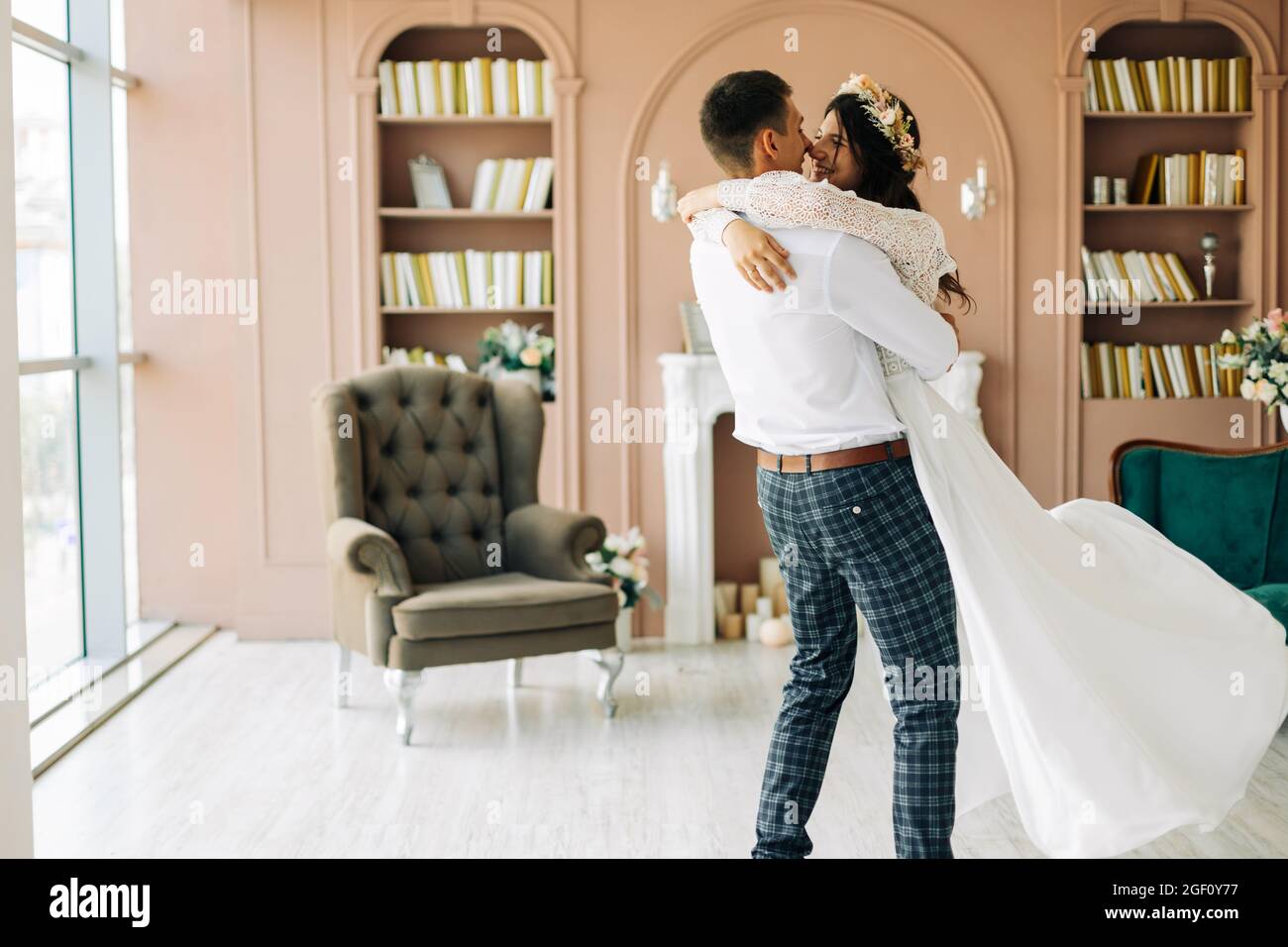 Happy wedding couple, attractive bride and groom hug each other, the ...