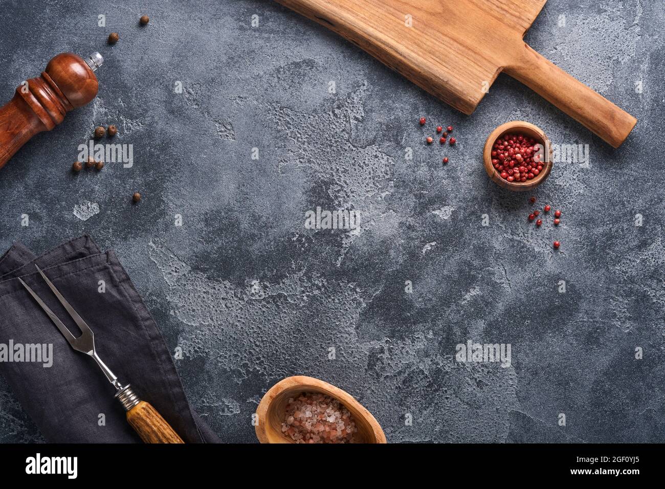 Old meat fork, black plate, black pepper and black pepper and spice ...