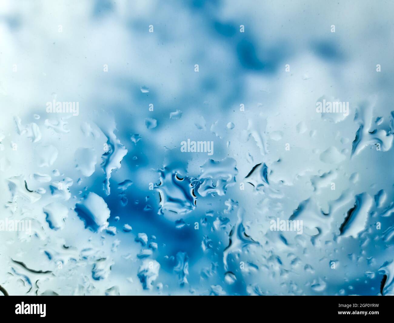 Rain drops running down a window in a close up view Stock Photo - Alamy