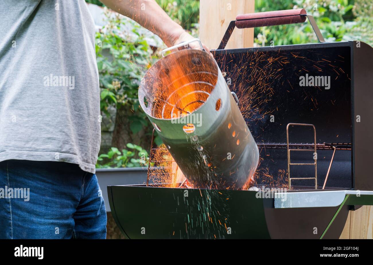 Preparation of barbeque grill using chimney starter for igniting ...
