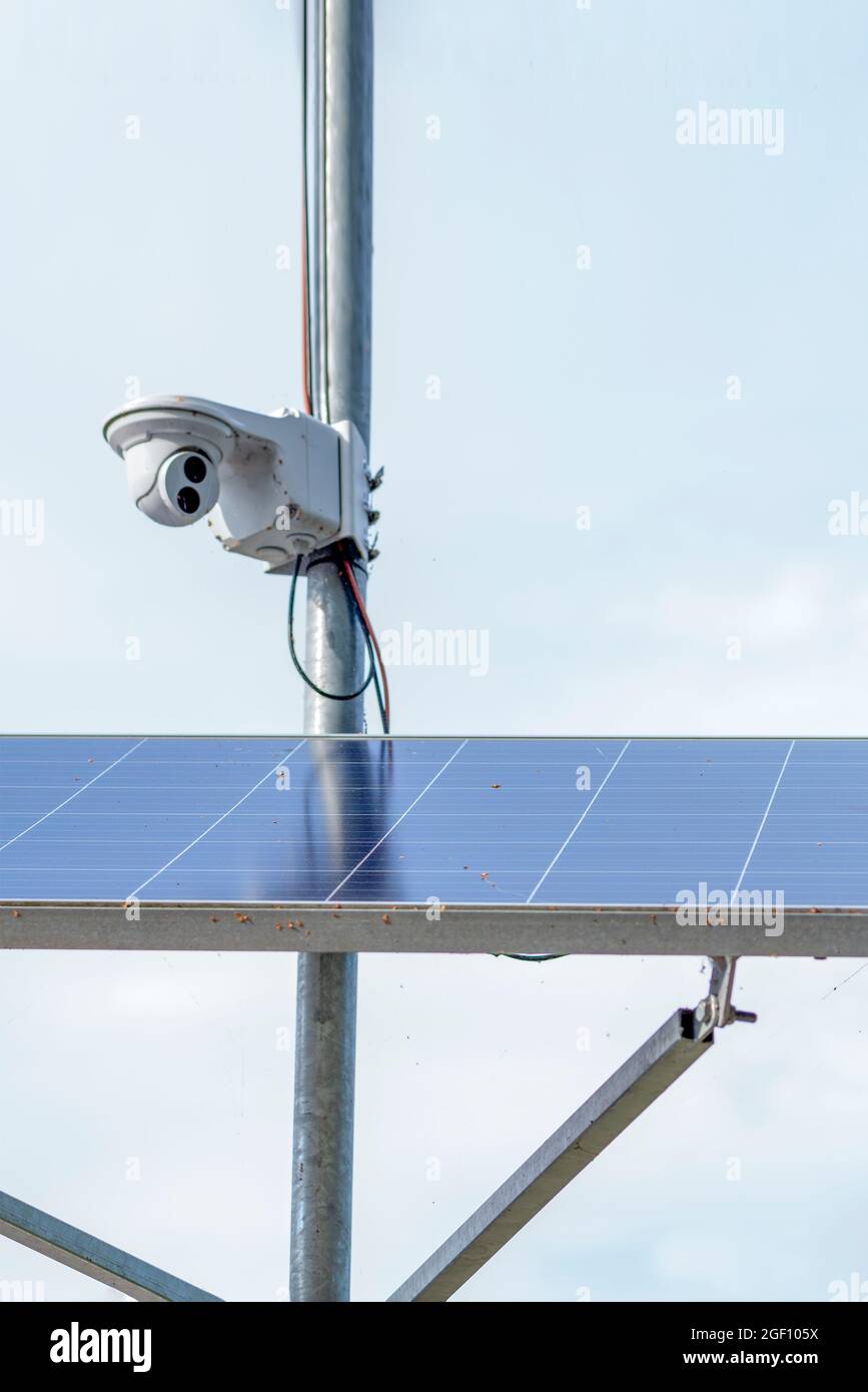 Solar powered surveillance camera. Solar panels powering a surveillance ...