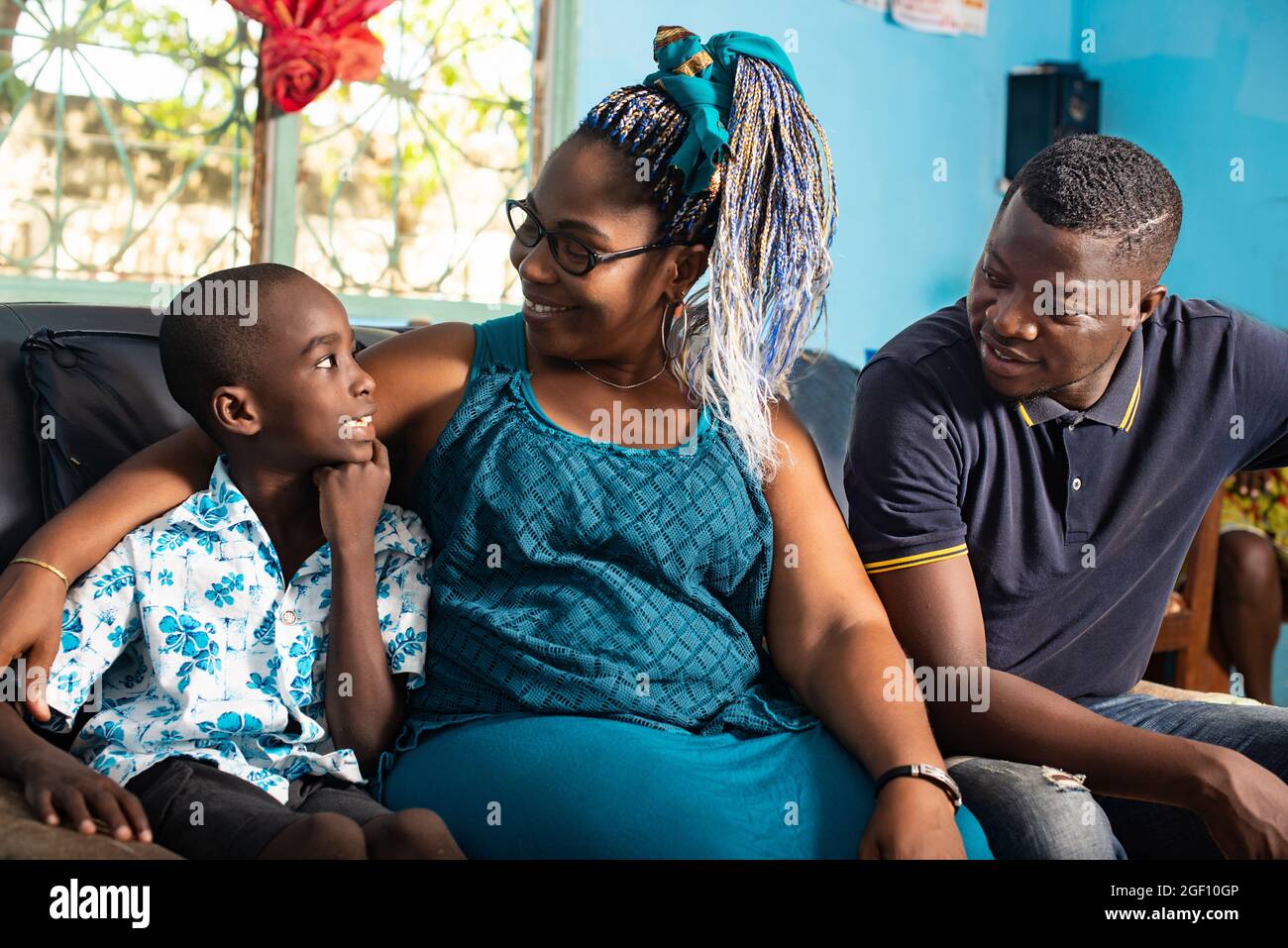 portrait of a beautiful African family sitting comfortably together on ...