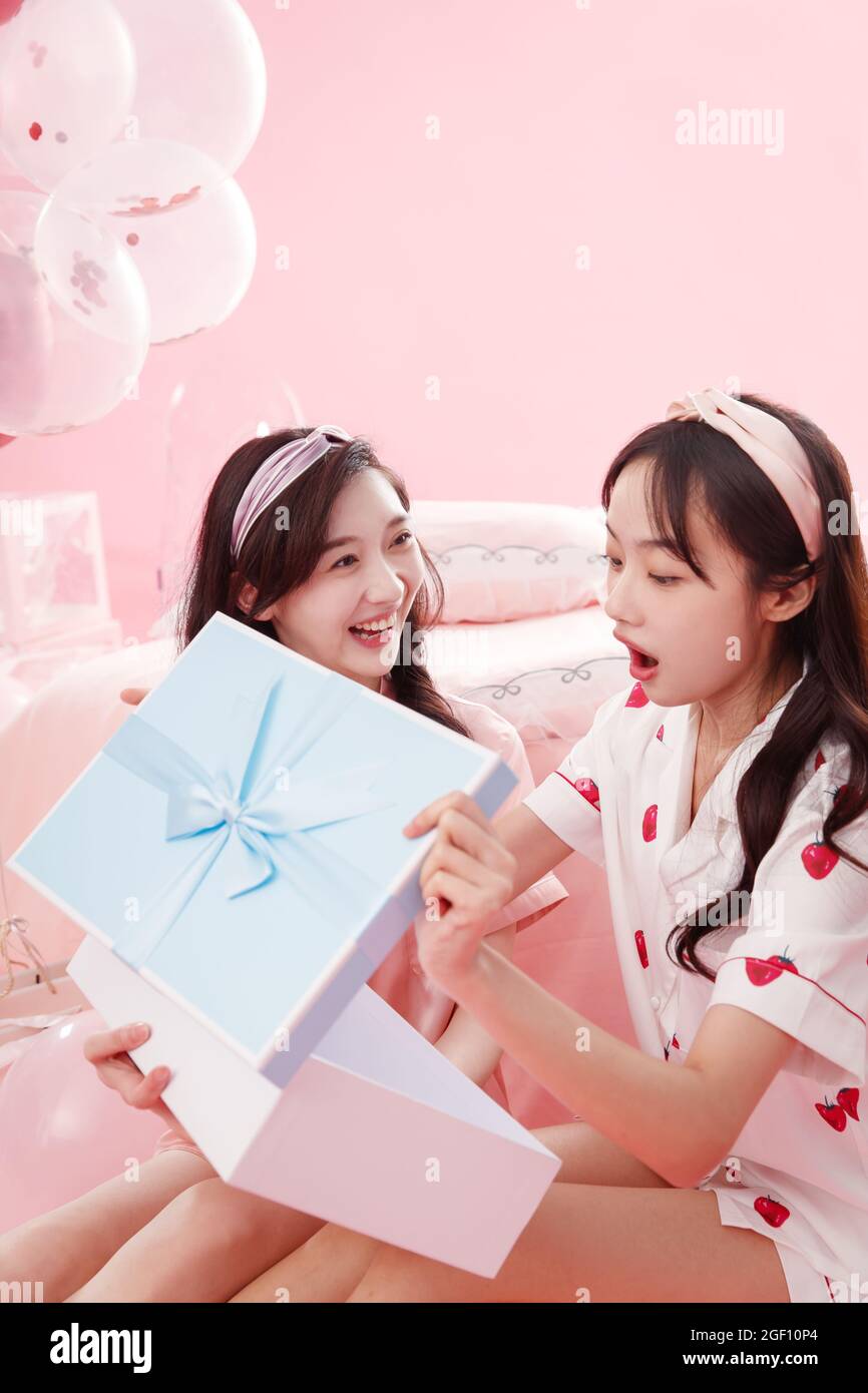 Two beautiful girls holding gifts hi-res stock photography and images ...