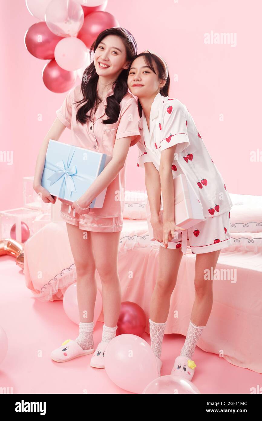 Two beautiful girls holding gifts hi-res stock photography and images ...