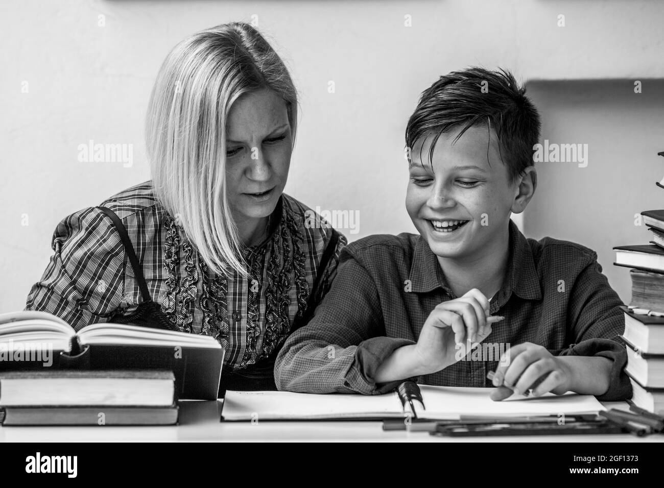 Student elementary school during homework with the help of a tutor ...