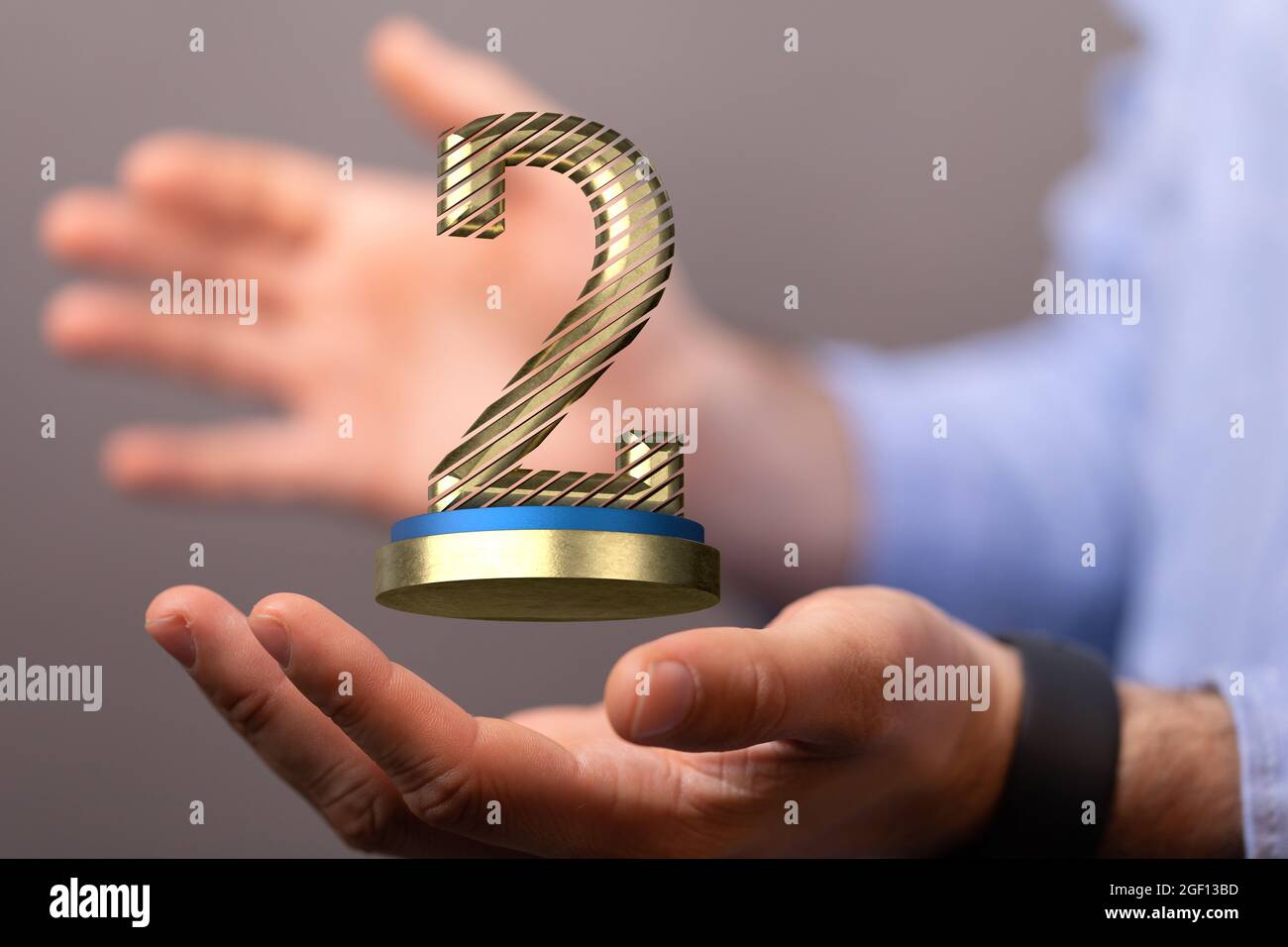 A 3D rendering of a 2nd place trophy in a real person's hand Stock ...