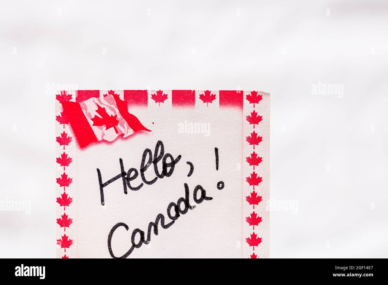 A handwriting saying 'Hello Canada' on a paper with Canada flag Stock ...