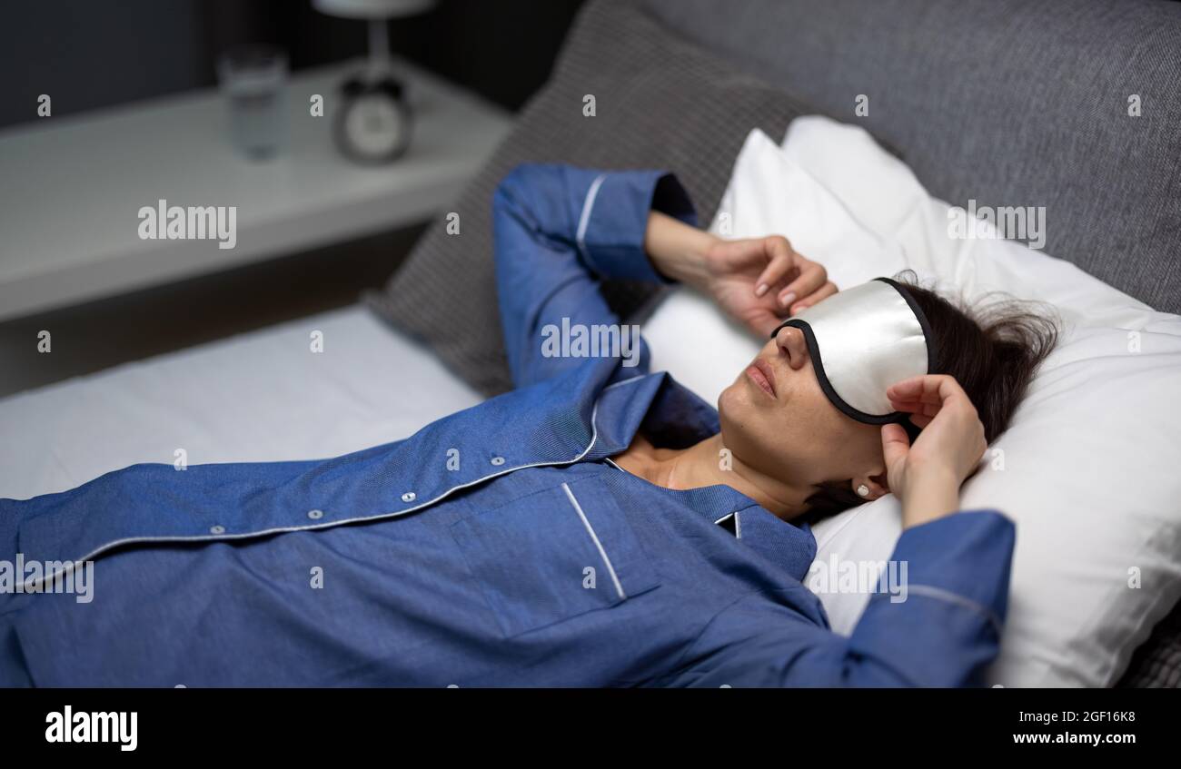 Woman and bed and sleep mask hi-res stock photography and images - Alamy