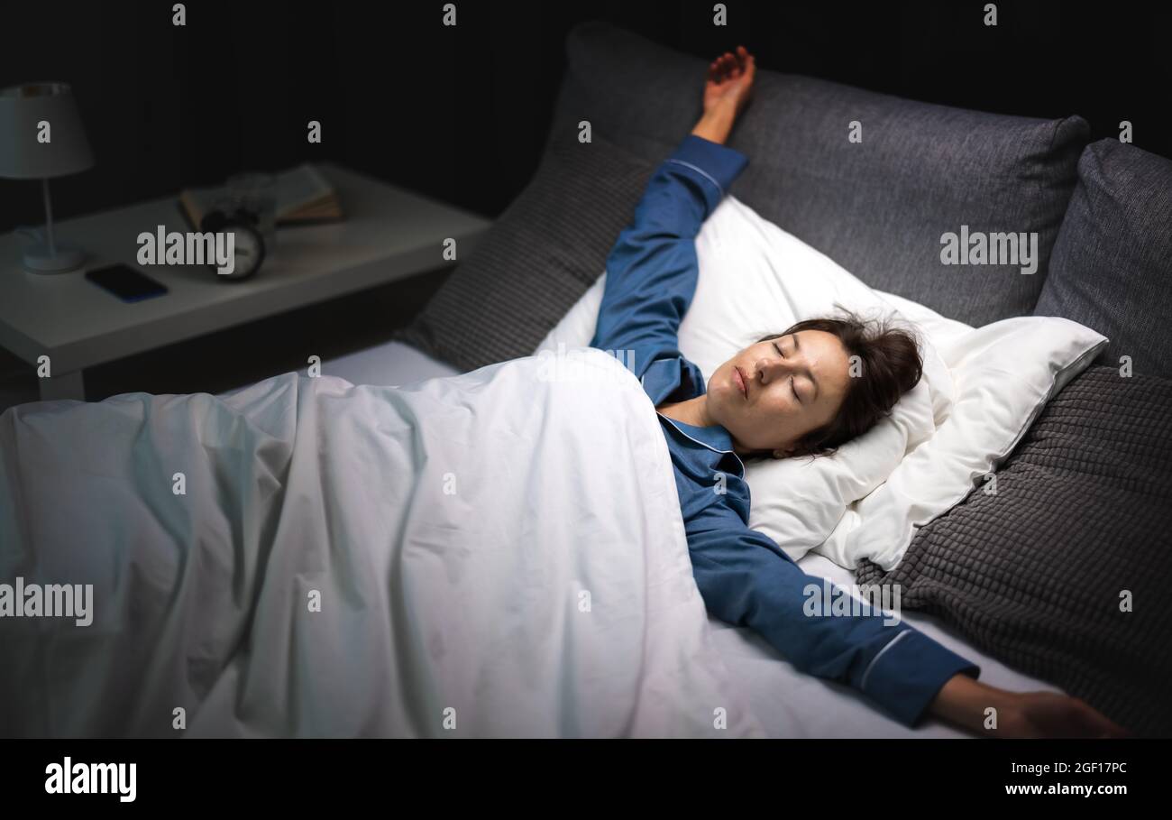 Woman sleeping well in bed Stock Photo - Alamy