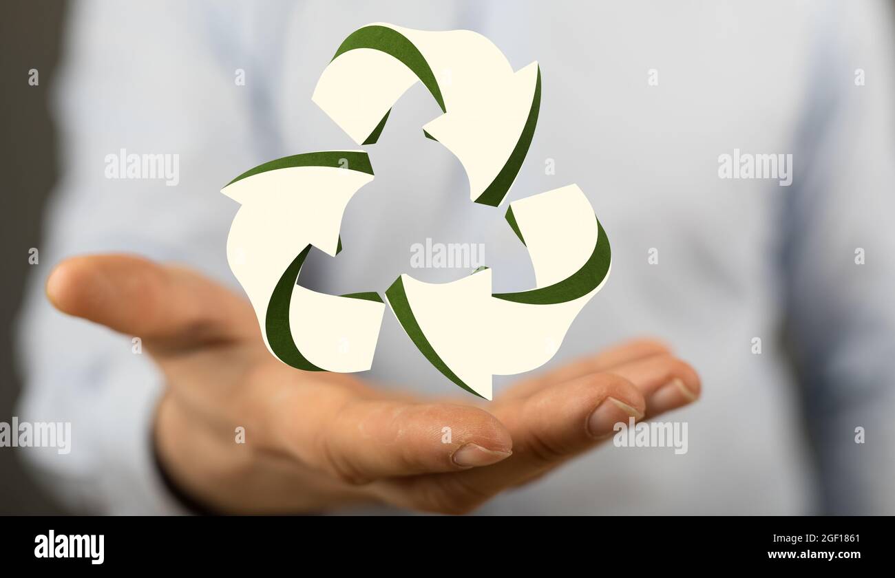 A 3D rendering of a recycling symbol with a real person holding it ...