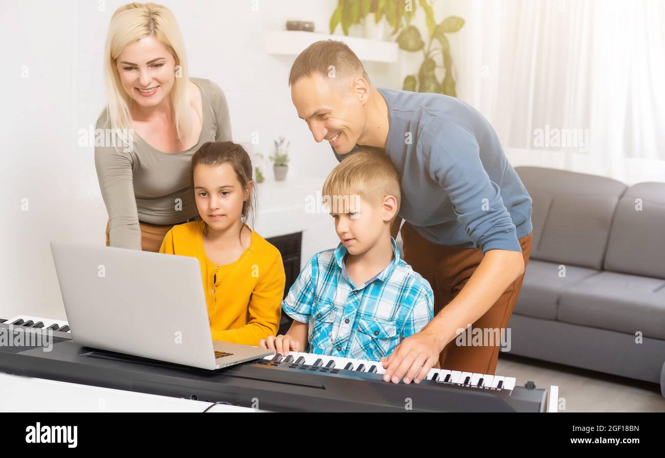 Brother and sister play the synthesizer. Children play at piano. family ...