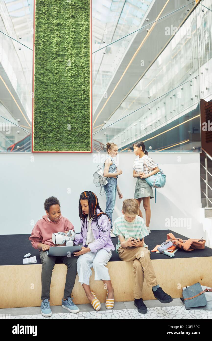 Vertical wide angle view at diverse group of children at break in ...