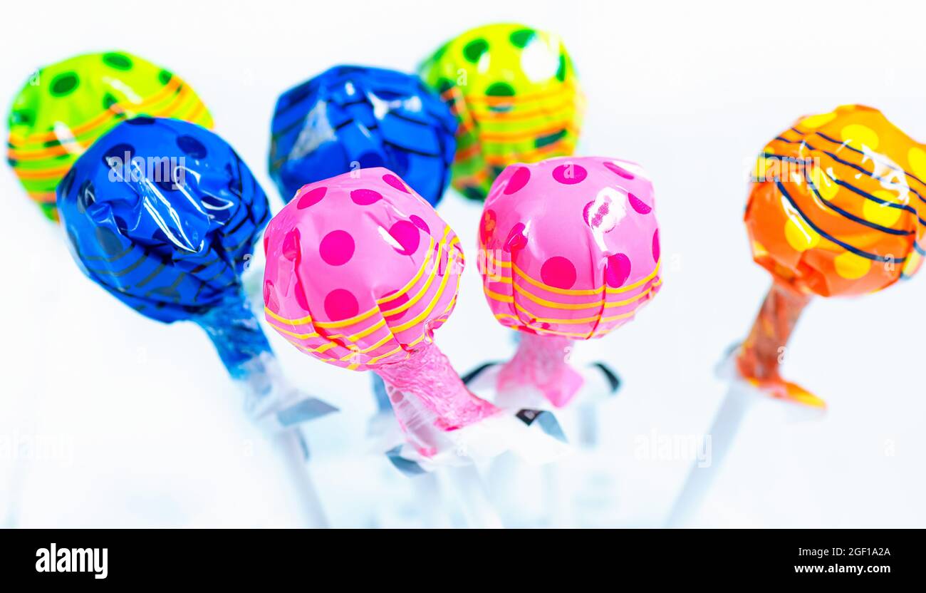 Colorful fun lollipops against a white background Stock Photo - Alamy