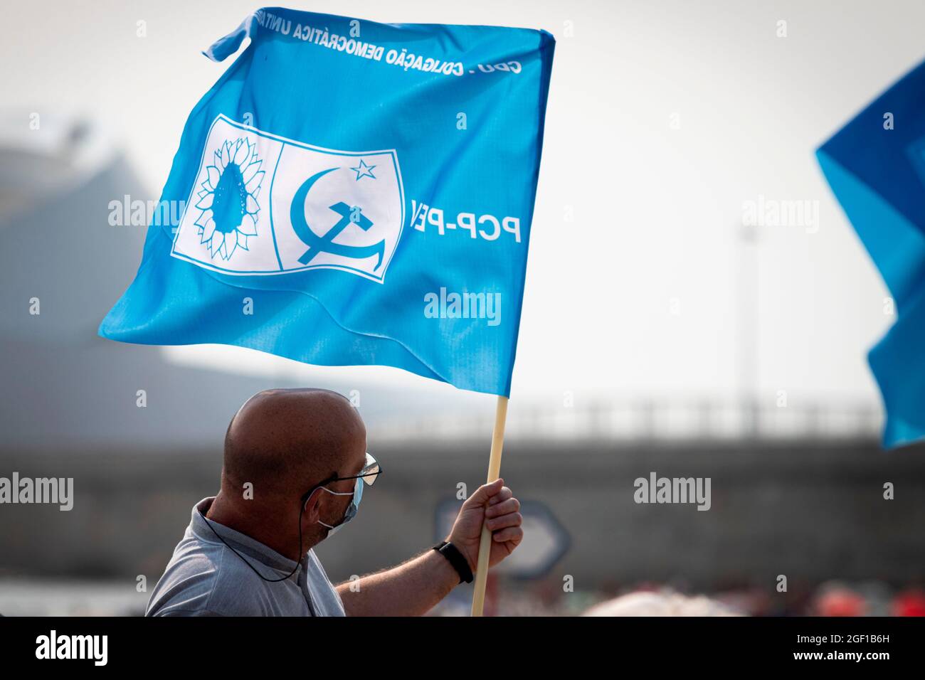 Matosinhos, Portugal. 22nd Aug, 2021. A man holds a flag of the PCP-PEV ...