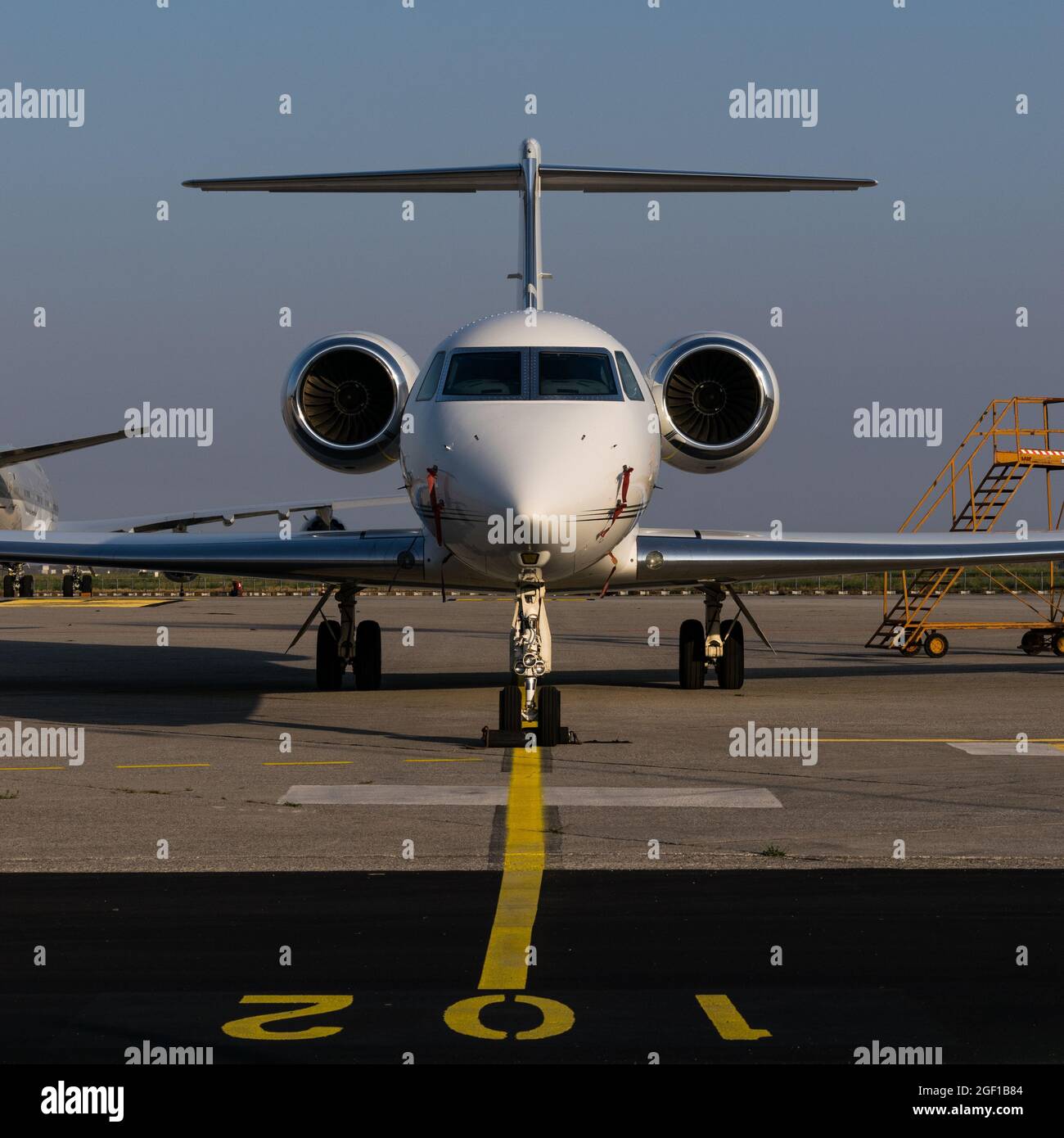A front view of a business jet aircraft at a tarmac Stock Photo - Alamy