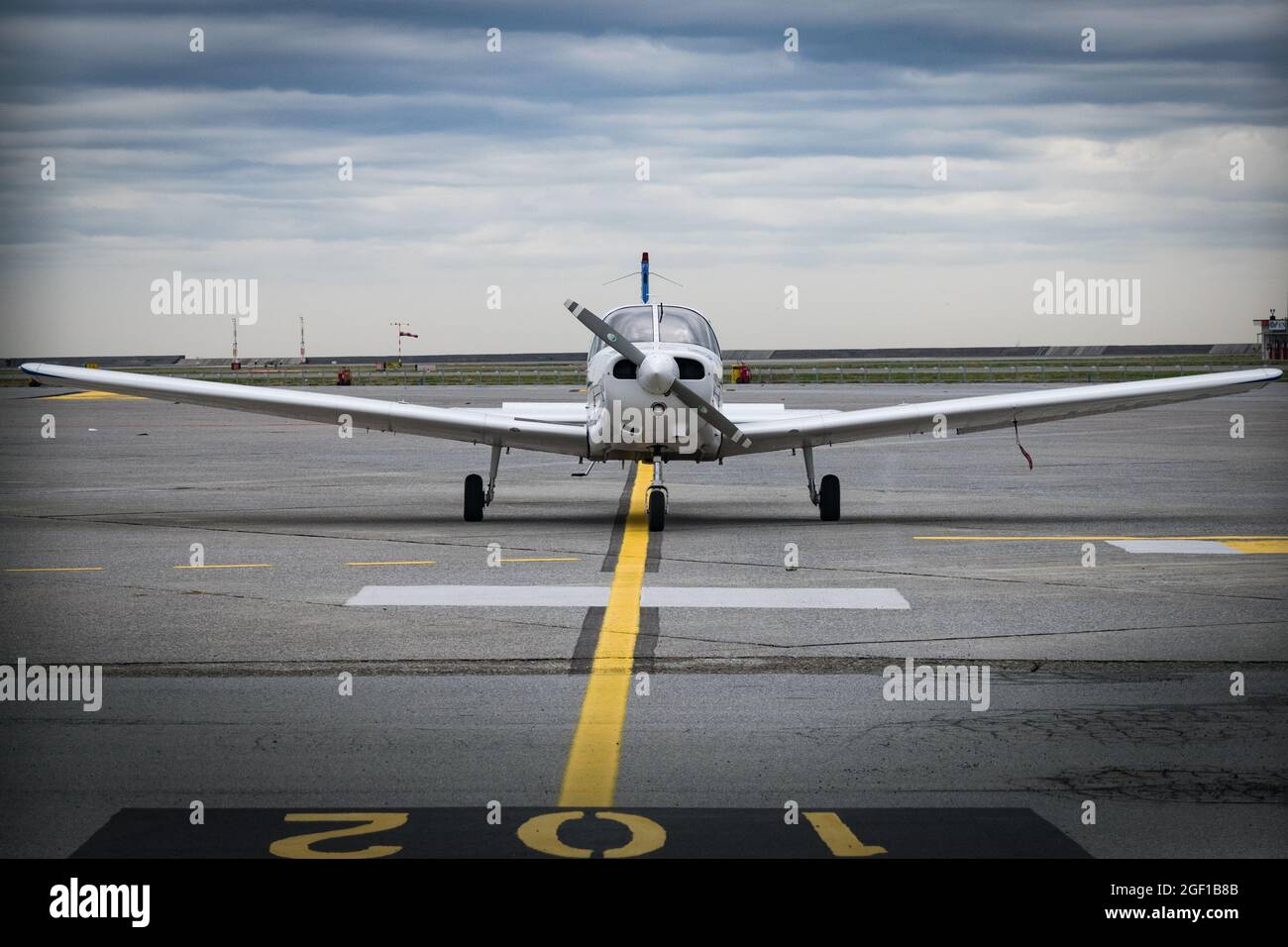 A closeup of the front view of a light aircraft with a nose propeller ...