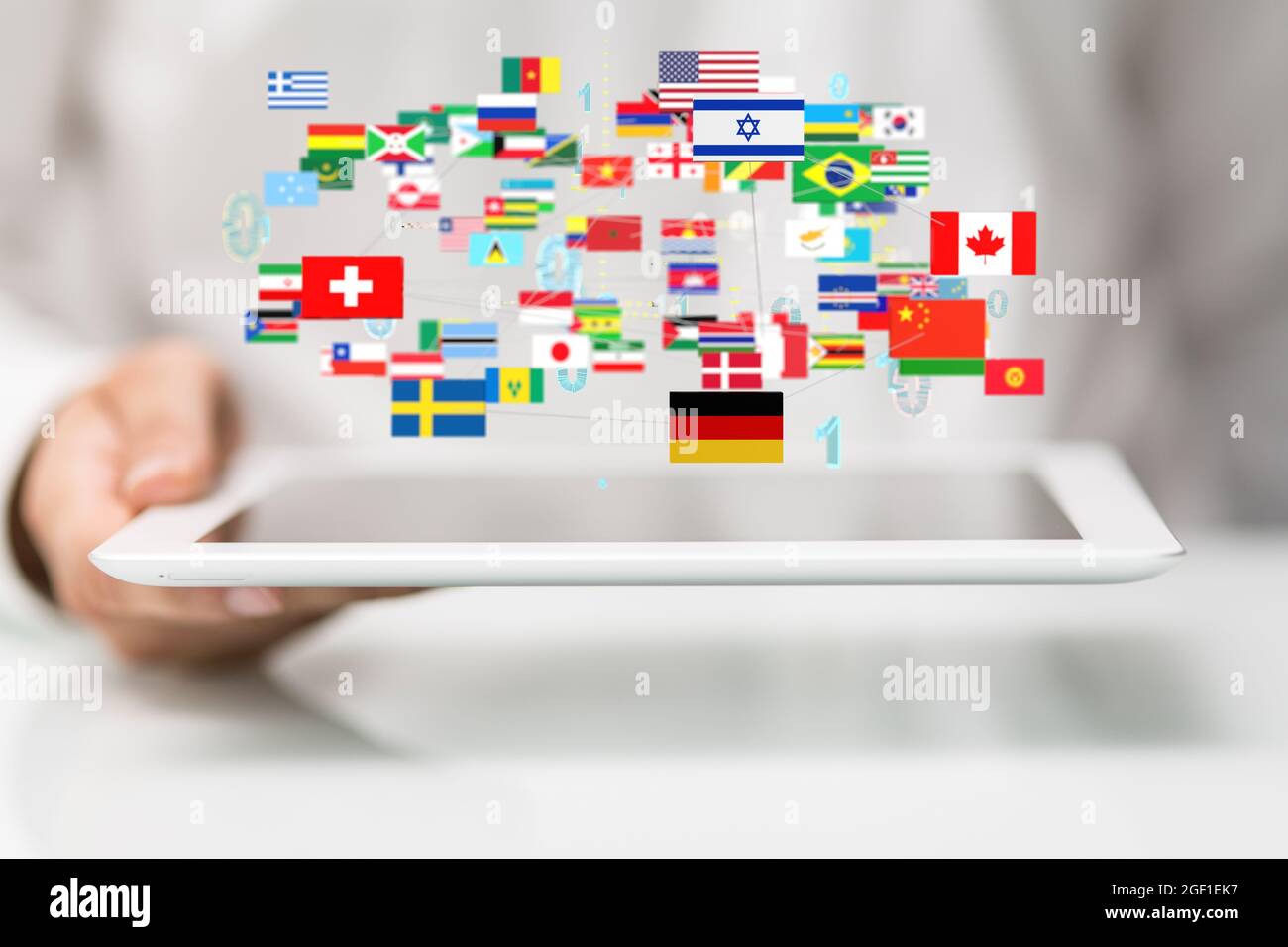 A man holding the virtual 3D national flags of different foreign ...