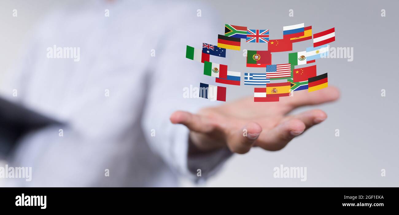 A man holding the virtual 3D national flags of different foreign ...