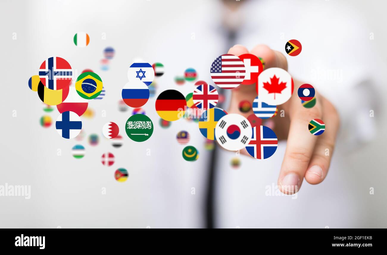 A man holding the virtual 3D national flags of different countries ...