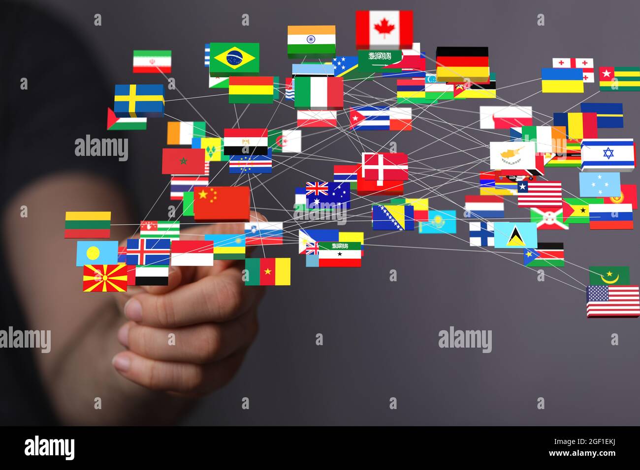 A man holding the virtual 3D national flags of different foreign ...