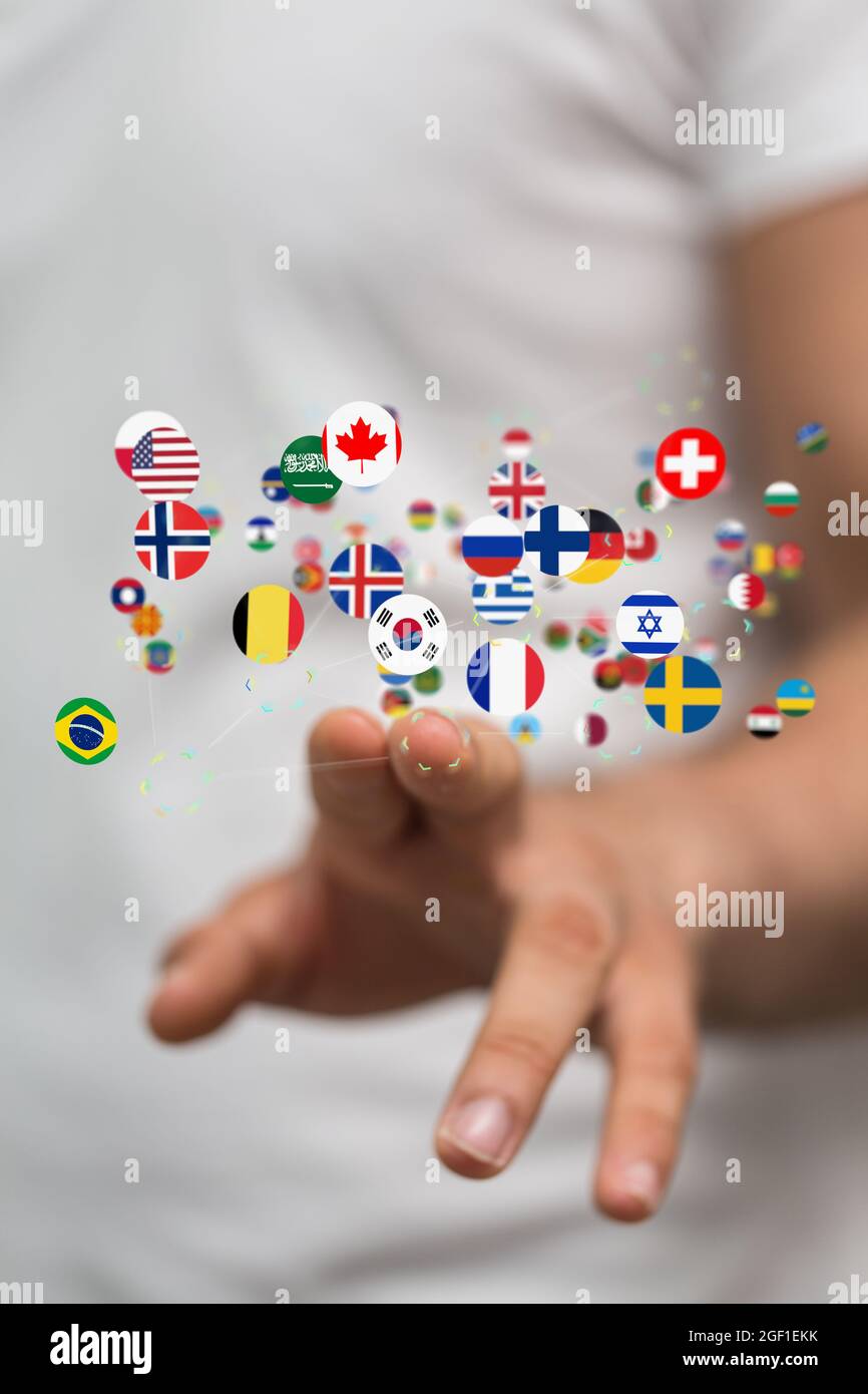 A man holding the virtual 3D national flags of different countries ...