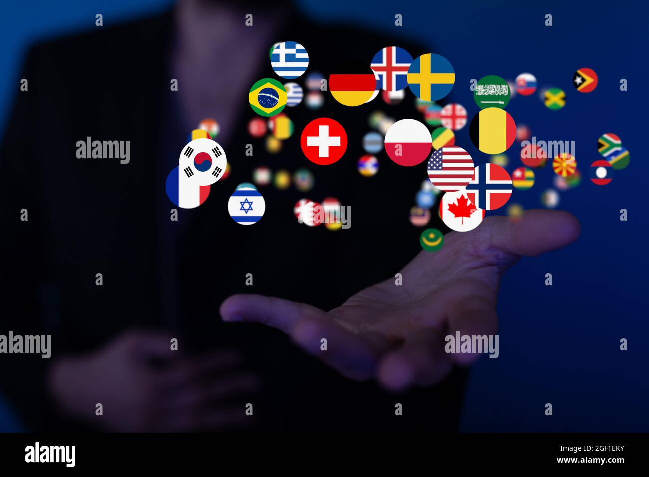 A woman holding the virtual 3D national flags of different foreign ...