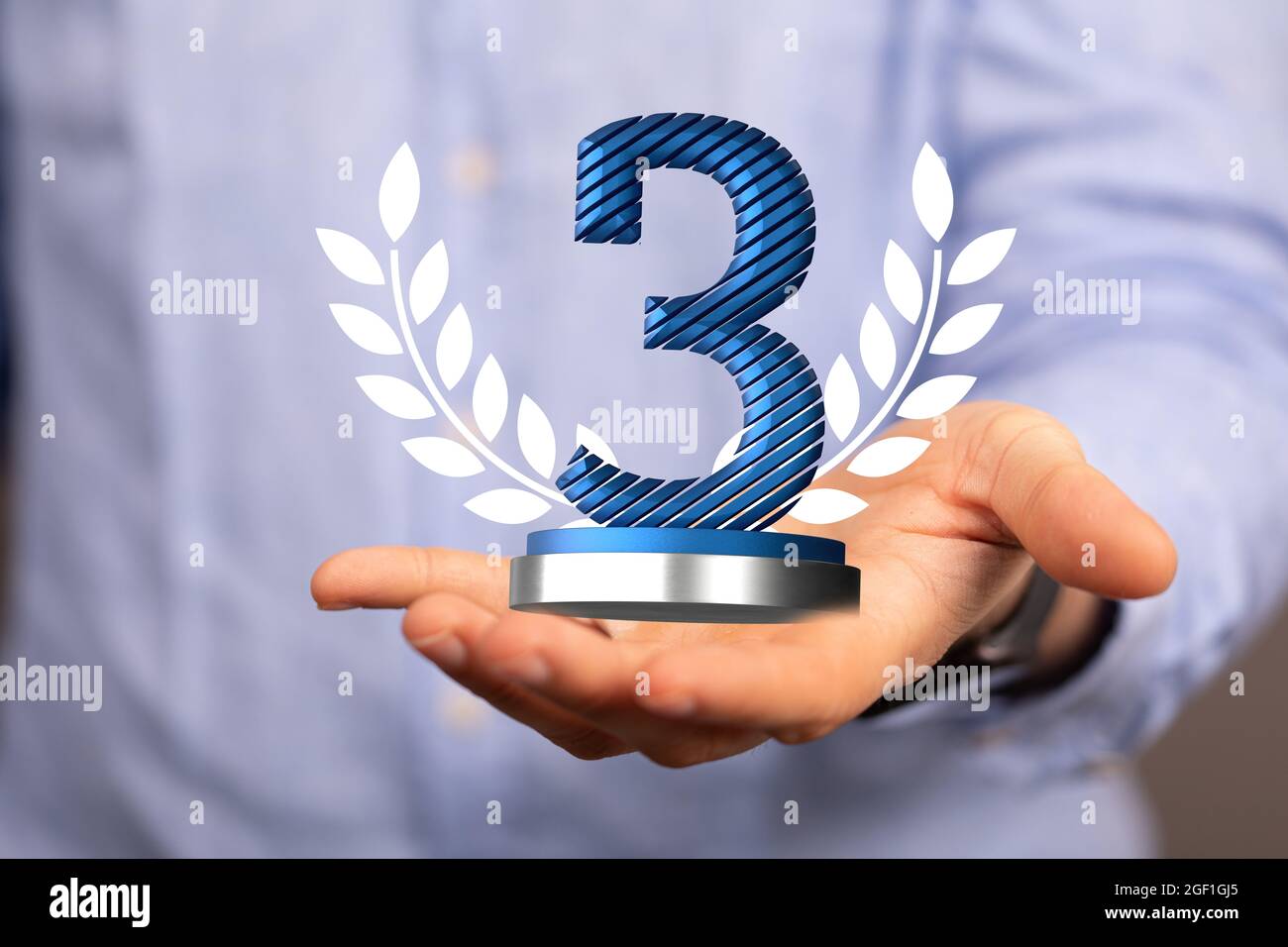 A 3d rendered 3rd place reward with olive wreath in male hand Stock ...