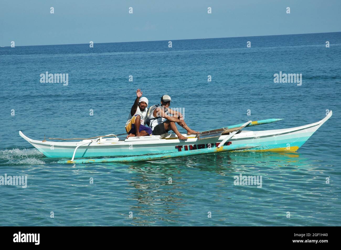 MINDOR, PHILIPPINES - Aug 04, 2006: The two fishermen driving a fishing ...