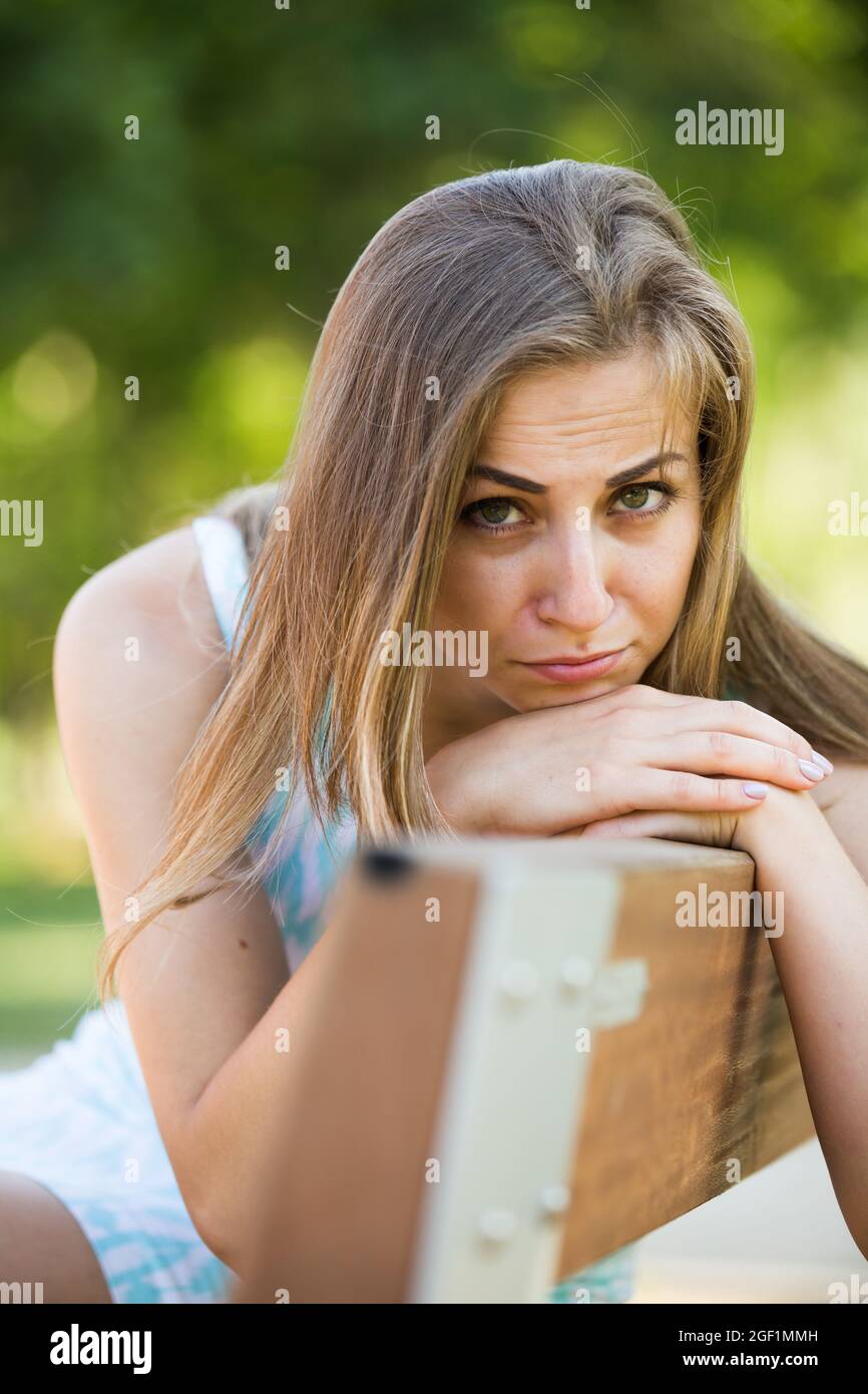 Sad girl sitting on bench hi-res stock photography and images - Alamy