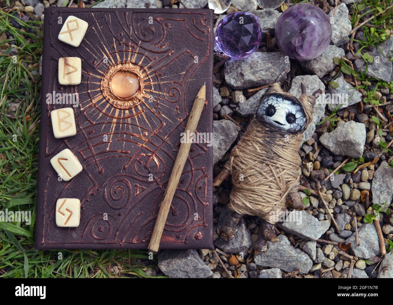 Witch book of magic spells, runes, voodoo doll and crystals in the ...