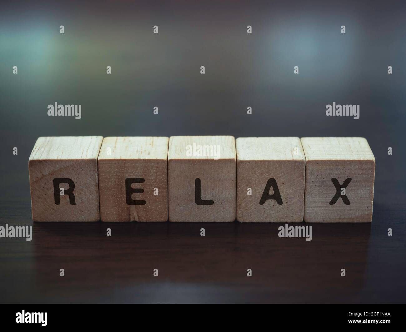 Relax, words on wooden cube blocks on dark brown wood background with ...