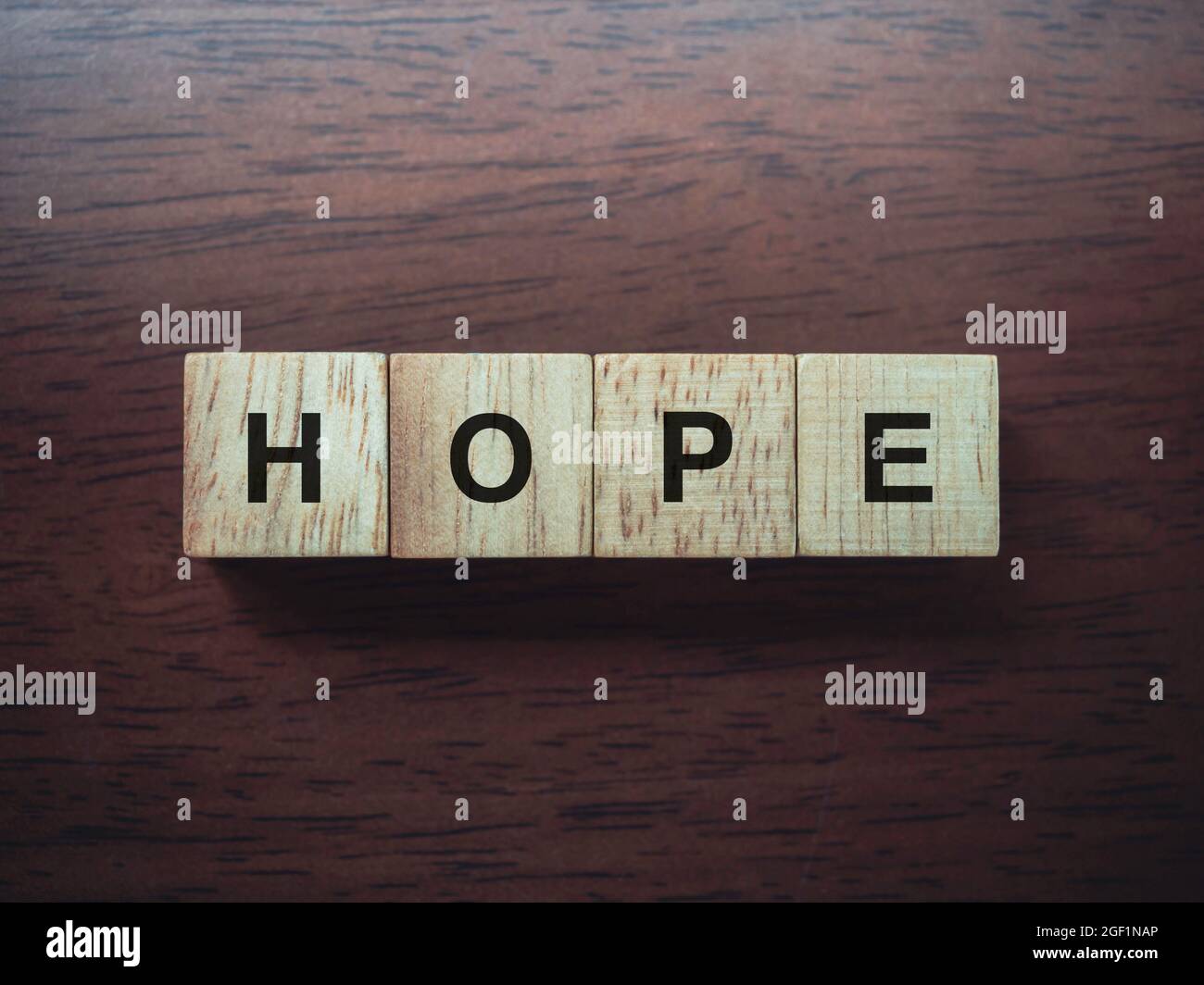 Hope, words on wooden cube blocks on brown wood desk background, close ...