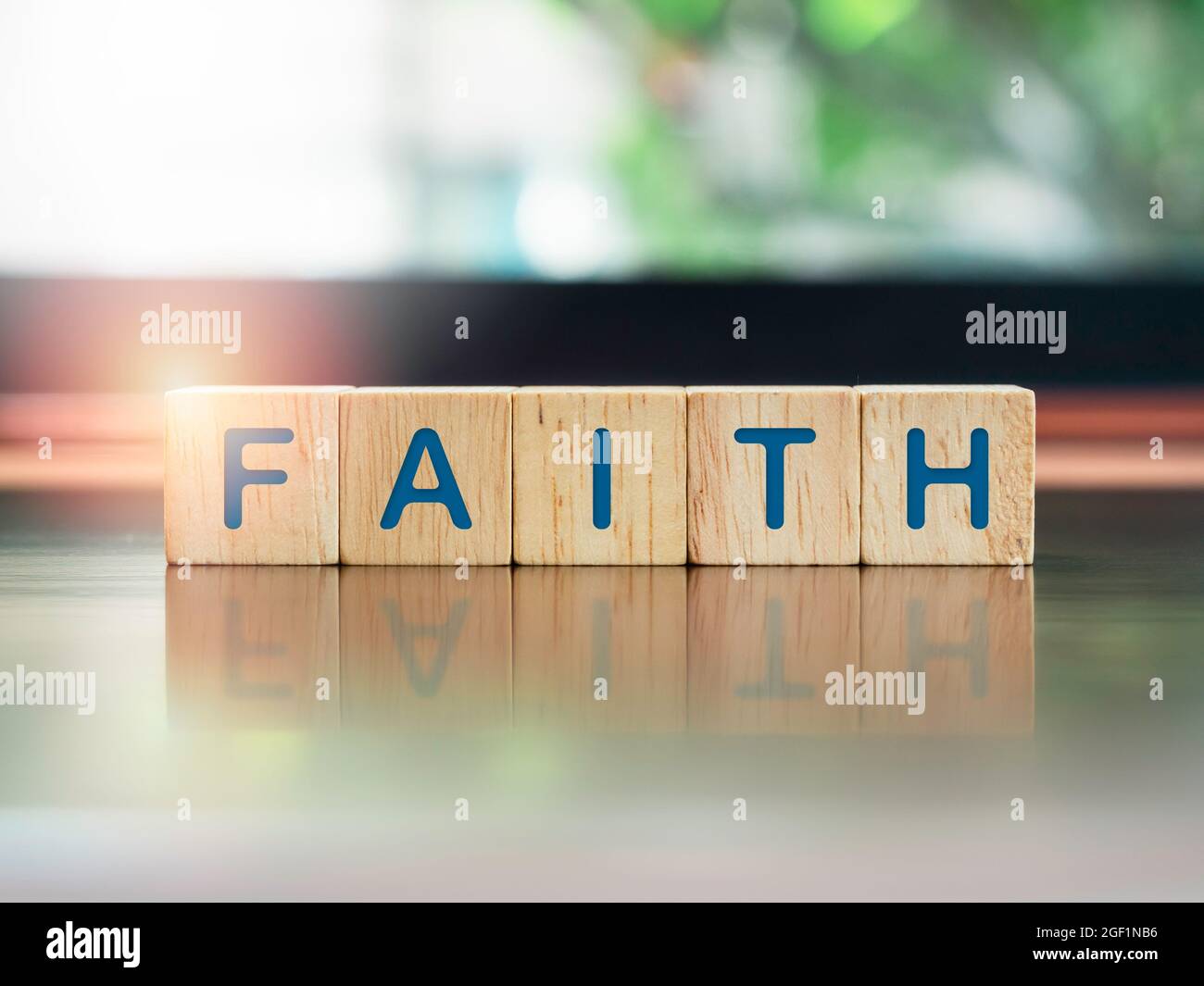 Faith, blue words on wooden cube blocks on brown wood desk and green ...