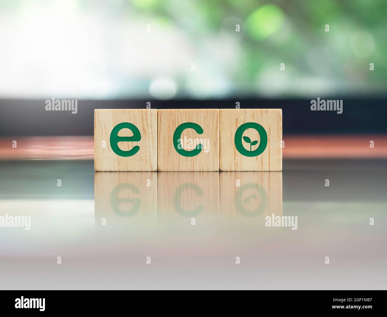 Eco, green words with leaf symbol on wooden cube blocks on brown wood ...