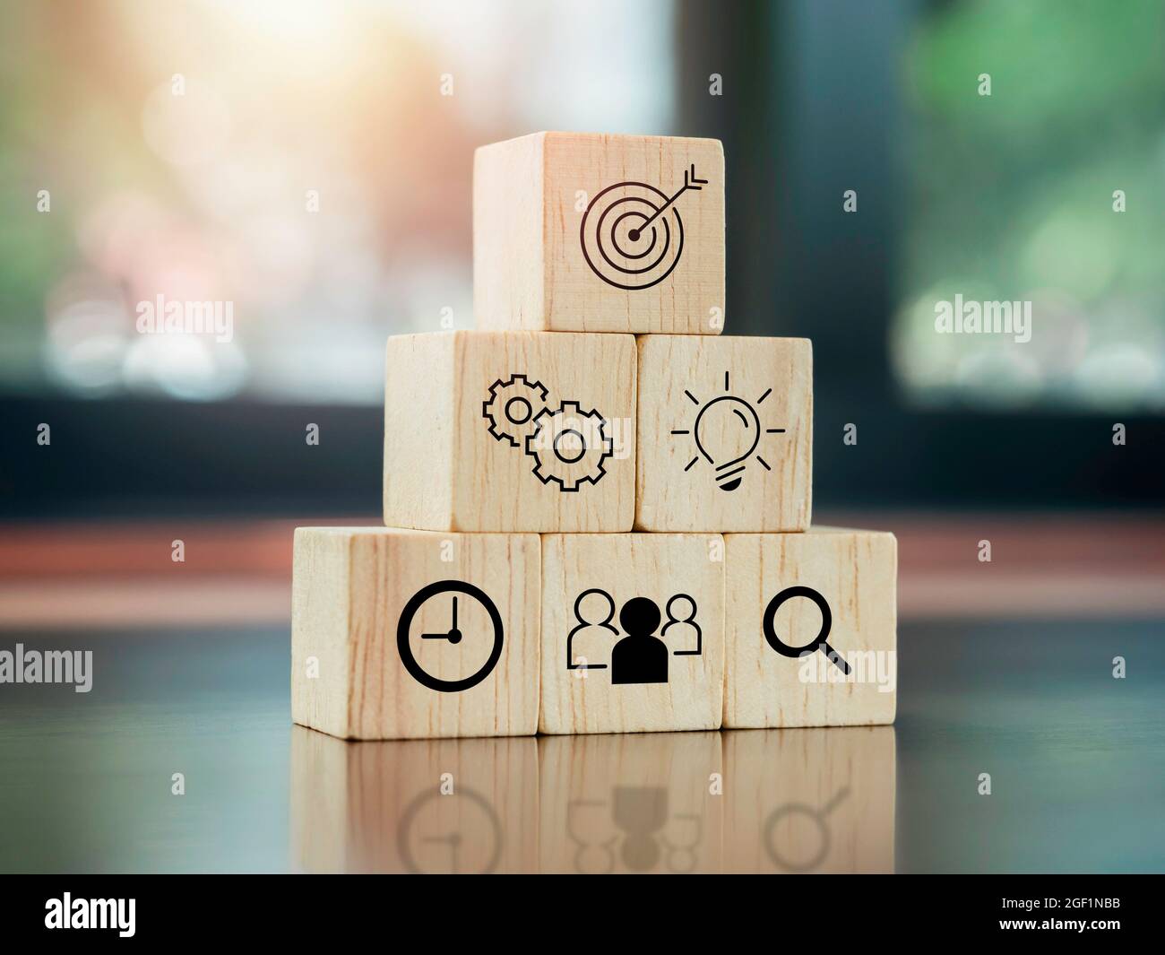 Modern business icons on wooden cube blocks, pyramid steps on desk ...