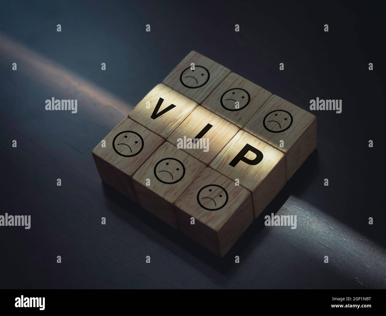 VIP words and boring faces emoticon on wooden blocks with the light on ...