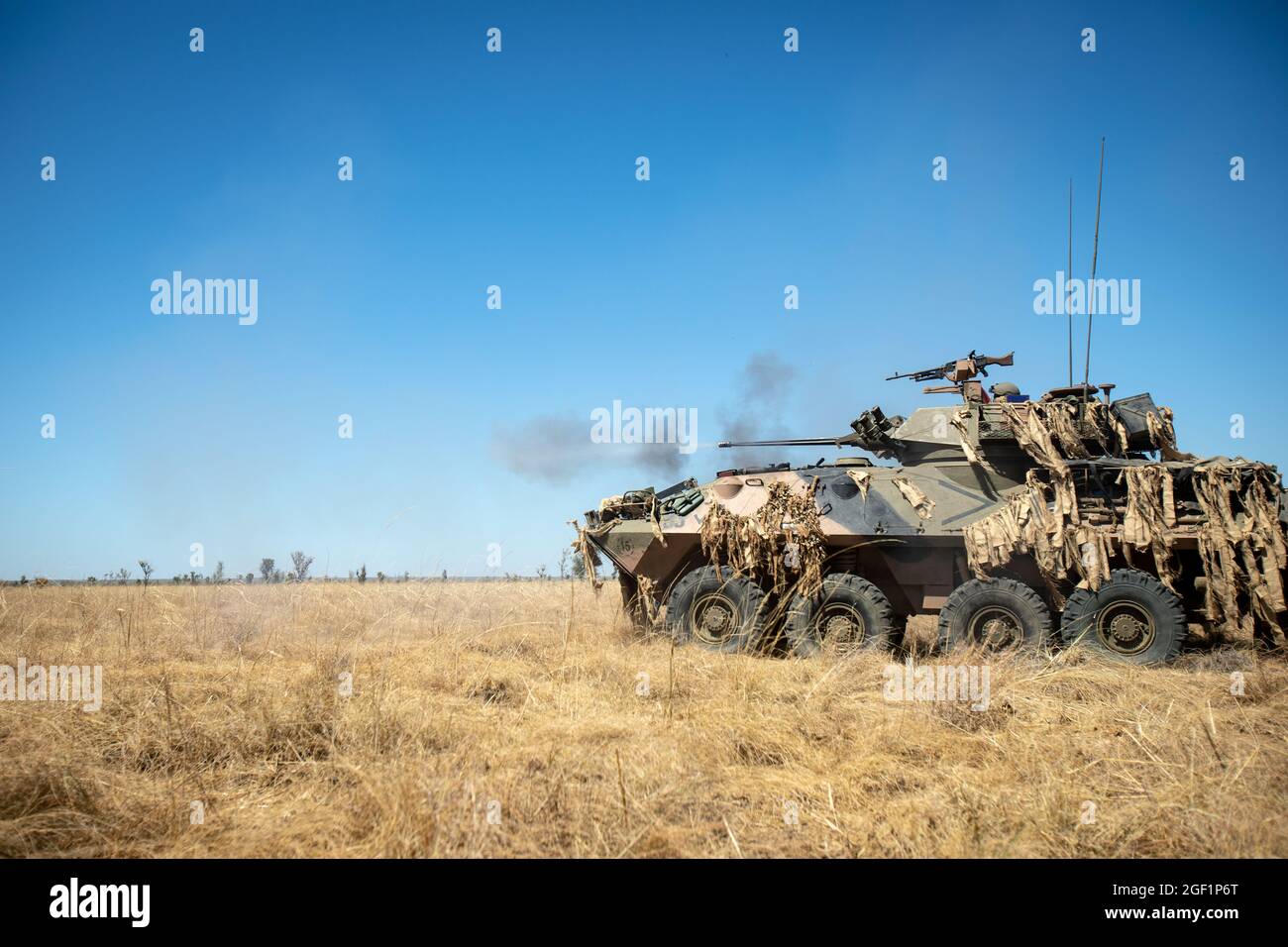 An Australian Service Light Armored Vehicle fires its weapon at a ...