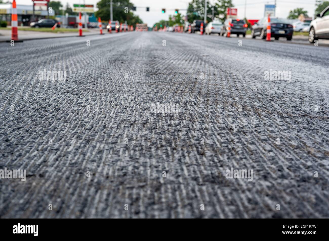 Low angle shot across a scarified street under construction with lanes ...