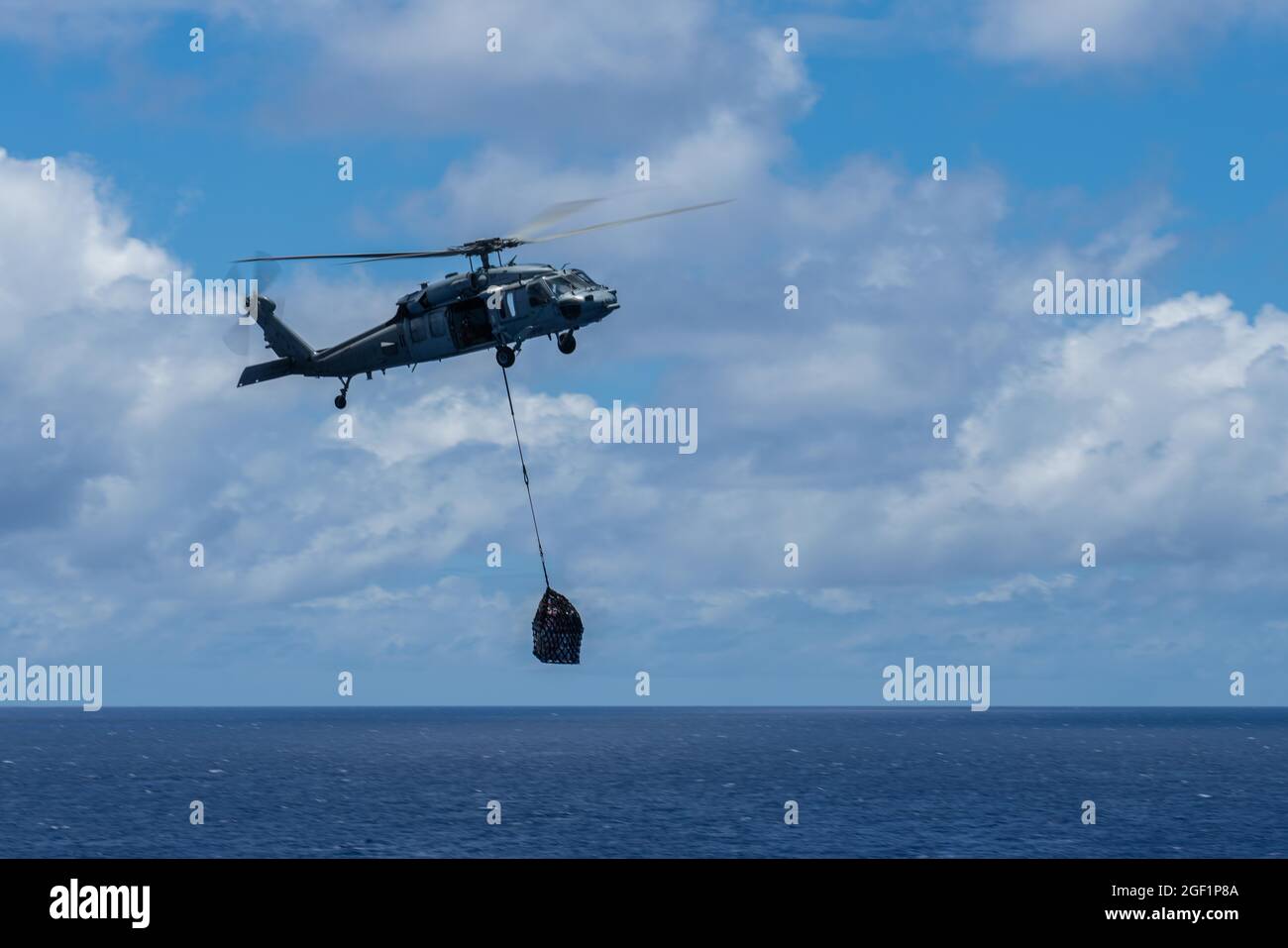PACIFIC OCEAN (August 14, 2021) An SH-60 Seahawk, attached to the dry ...