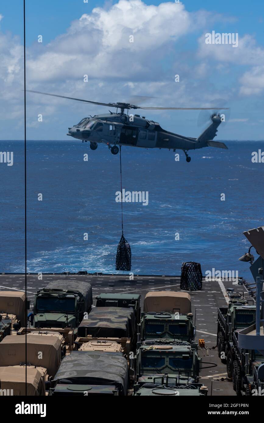 PACIFIC OCEAN (August 14, 2021) An SH-60 Seahawk, attached to the dry ...