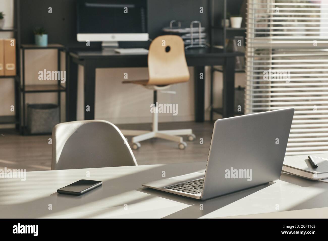 Close up background image of minimal home office desk lit by sunlight ...