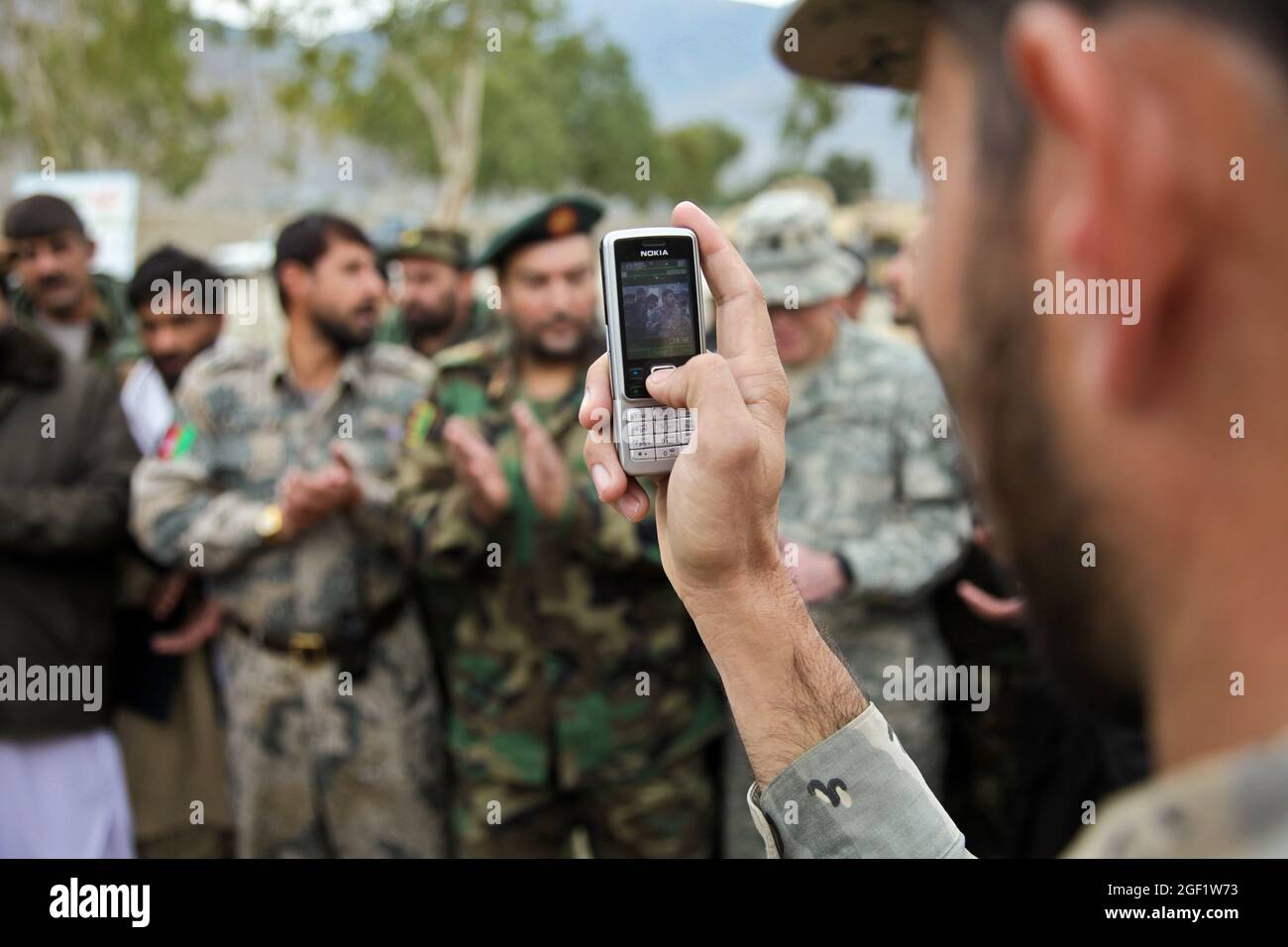 An Afghan border patrol soldier records video with his camera phone ...