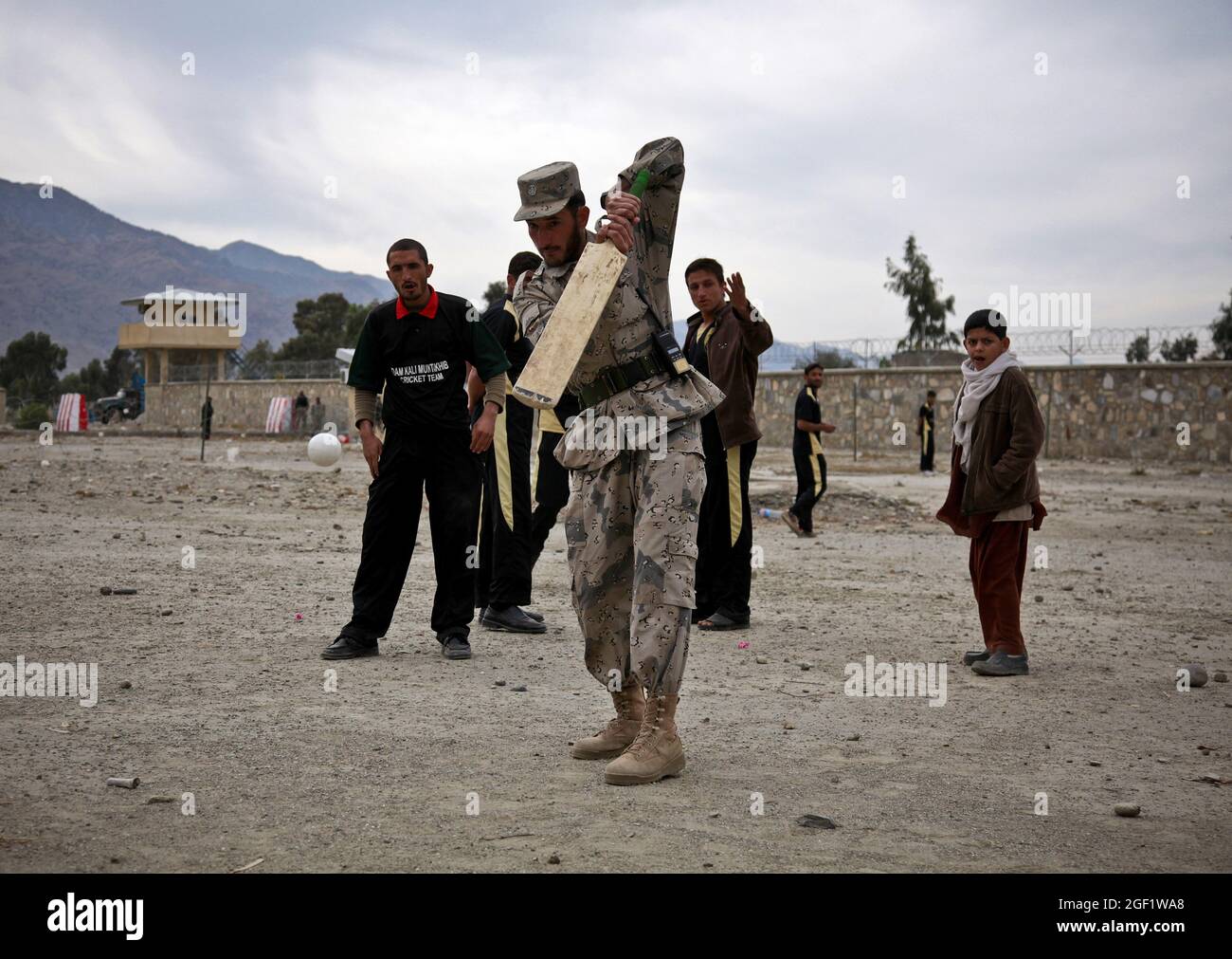 An Afghan border patrol soldier plays cricket after the ground breaking ...