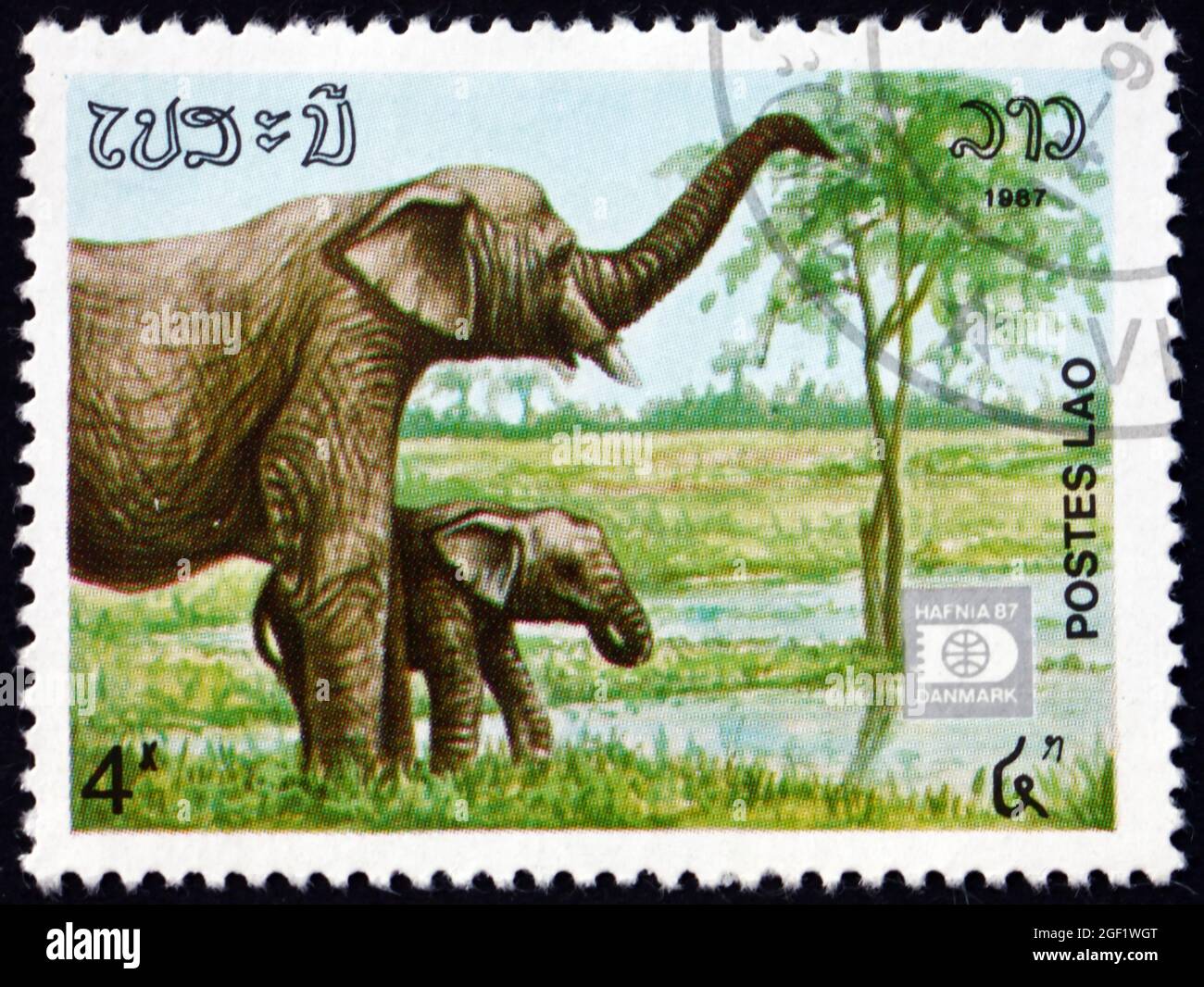 LAOS - CIRCA 1987: a stamp printed in Laos shows Indian elephant ...