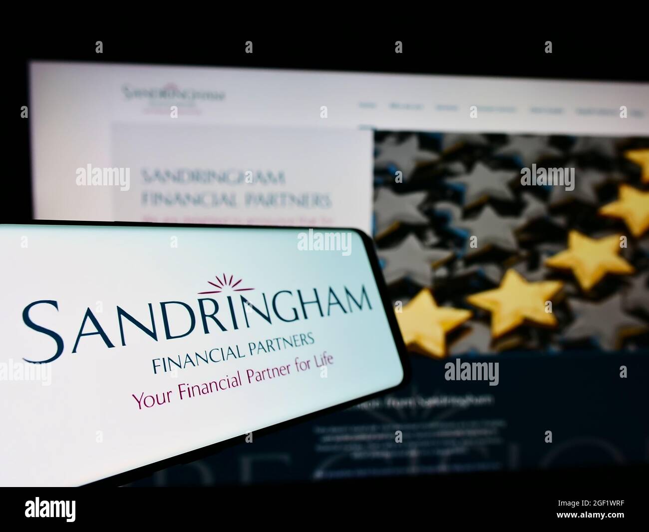 Cellphone with logo of British company Sandringham Financial Partners ...