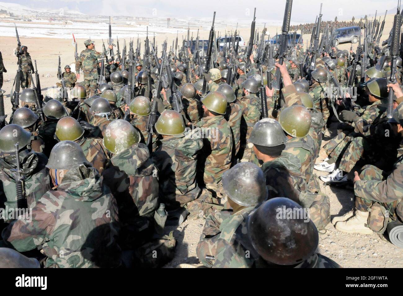 Afghan National Army trainees raise their weapons in acknowledgment ...