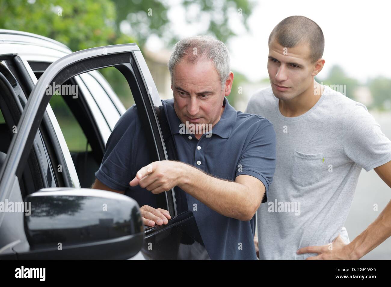 father and son checking a car Stock Photo - Alamy