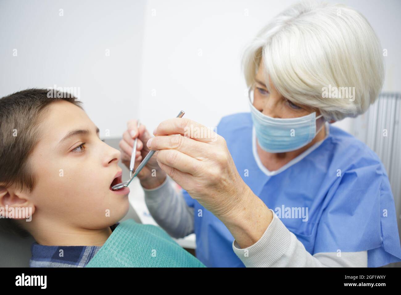 senior female doctor taking care of kid Stock Photo - Alamy