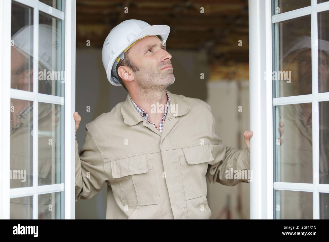 male worker is opening window Stock Photo - Alamy