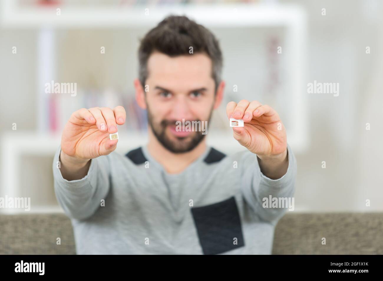 man holding sim card in each hand Stock Photo - Alamy